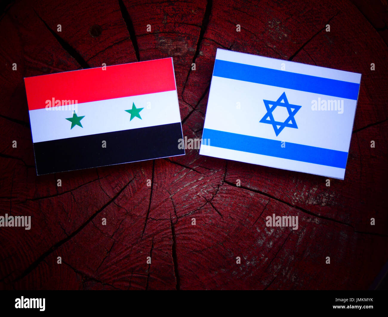 Syrian flag with Israeli flag on a tree stump isolated Stock Photo - Alamy