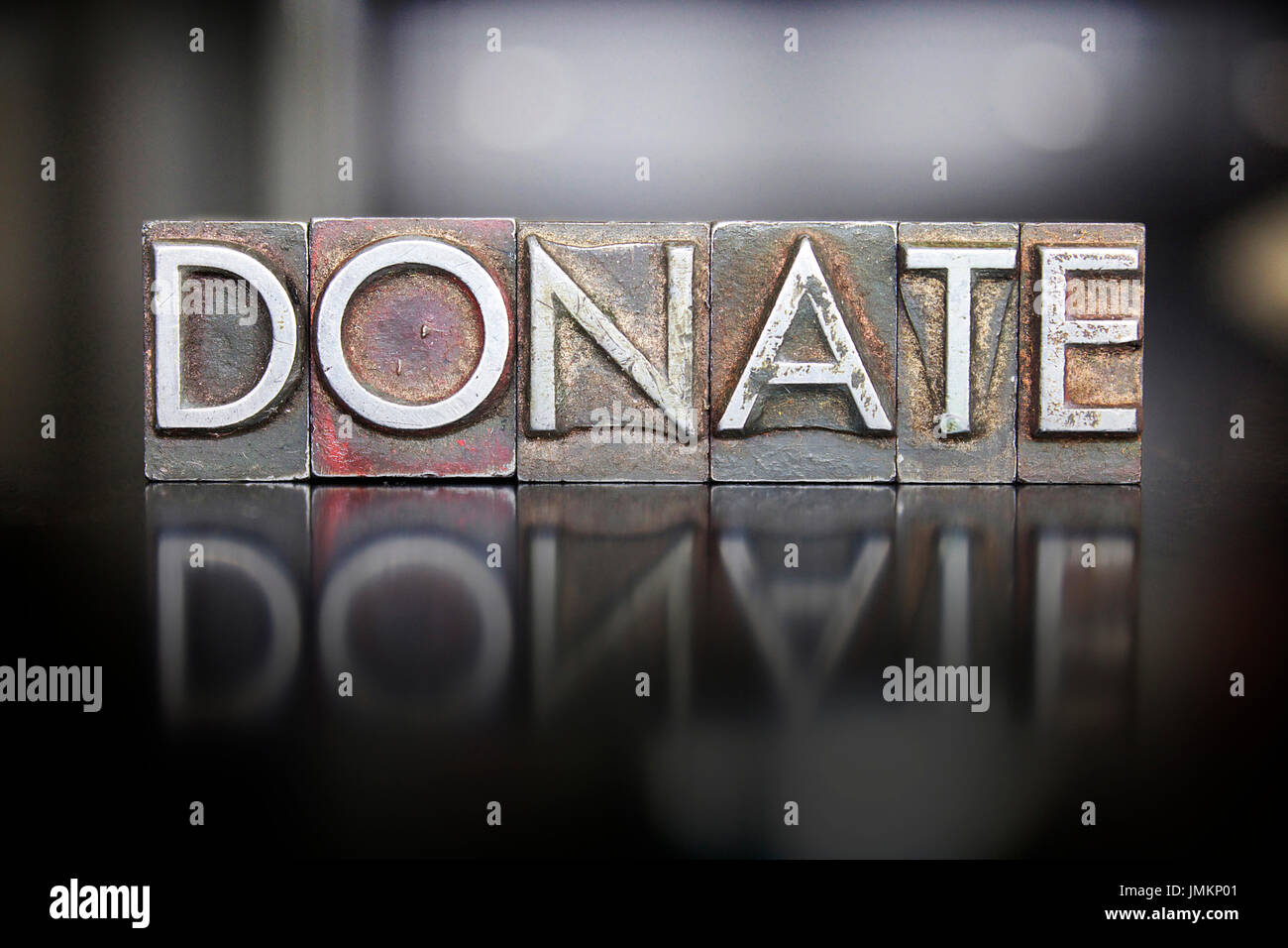 The word DONATE written in vintage letterpress type Stock Photo - Alamy