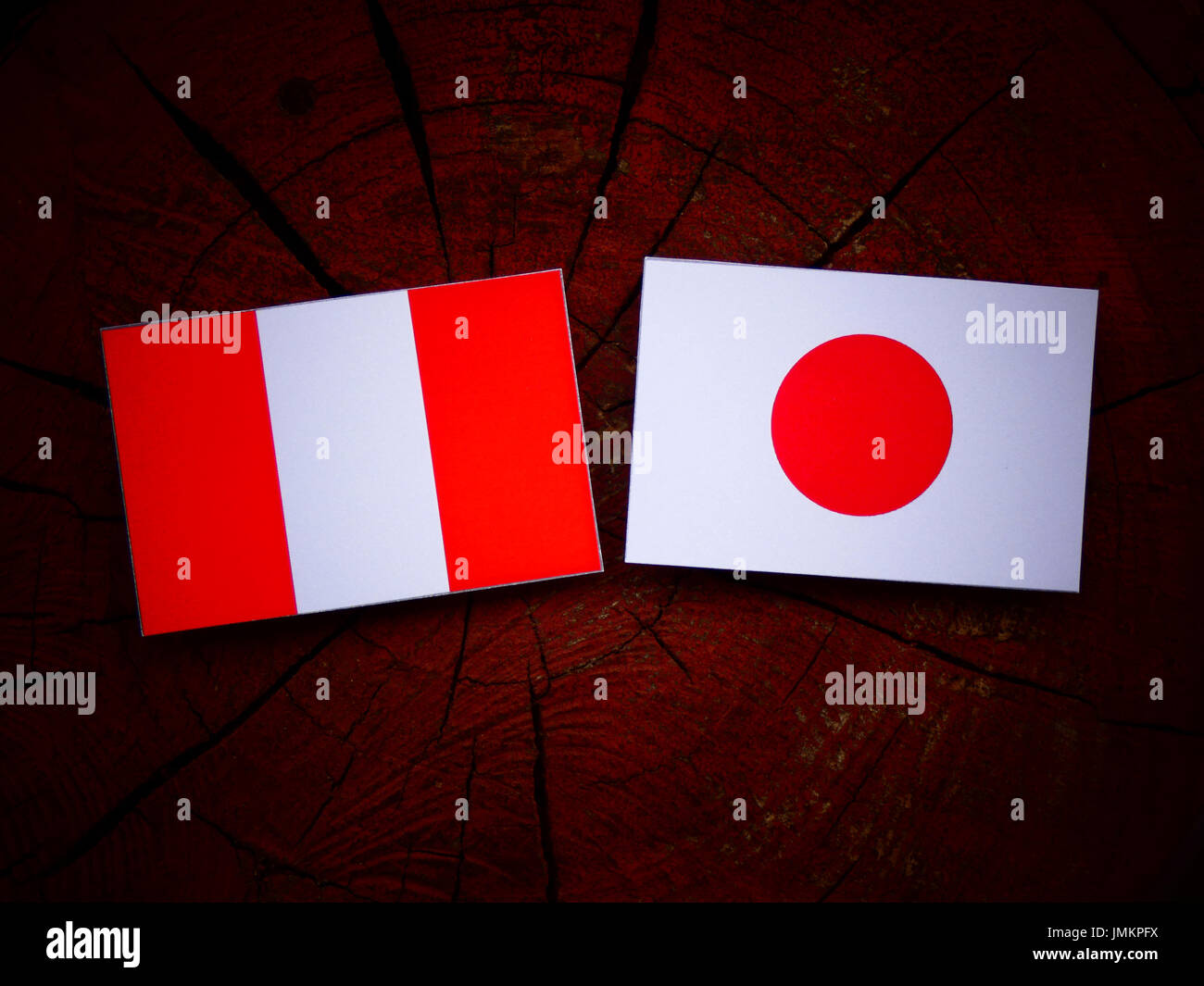 Peruvian flag with Japanese flag on a tree stump isolated Stock Photo ...