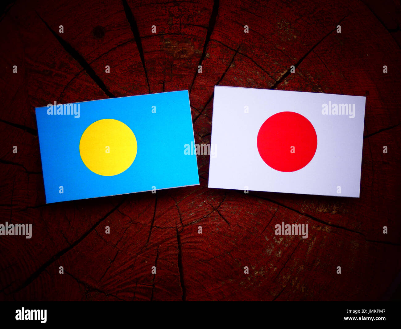 Palau flag with Japanese flag on a tree stump isolated Stock Photo - Alamy