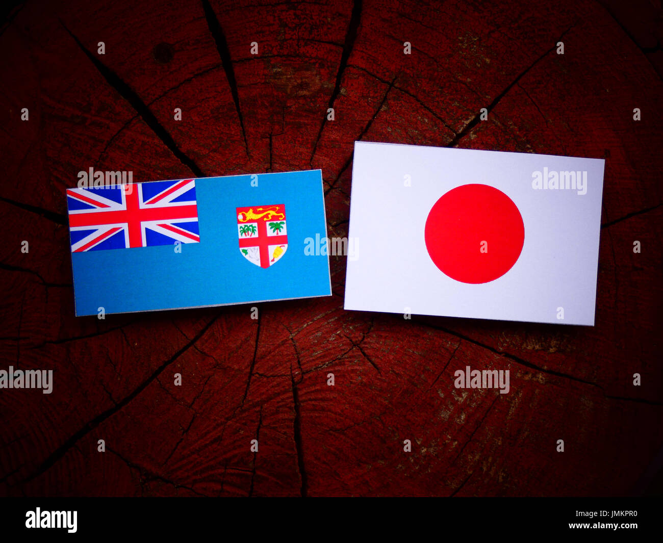 Fijian flag with Japanese flag on a tree stump isolated Stock Photo - Alamy