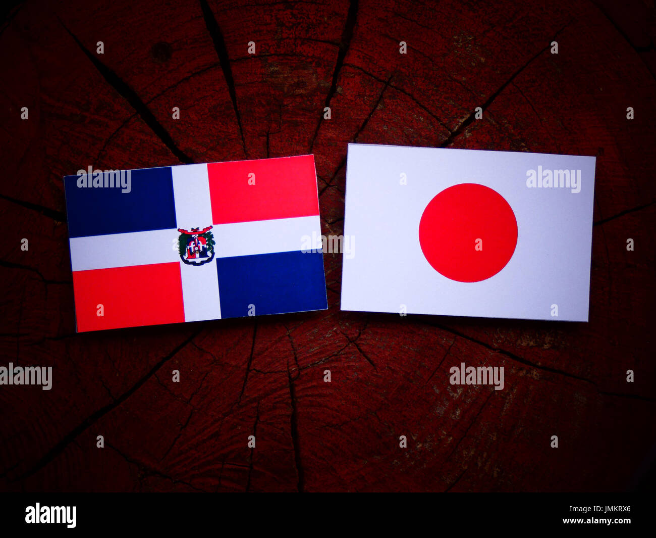 Dominican Republic flag with Japanese flag on a tree stump isolated ...