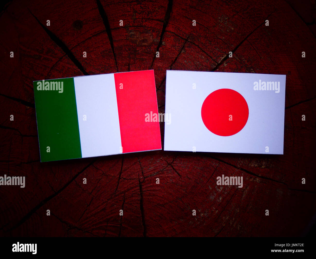 Italian flag with Japanese flag on a tree stump isolated Stock Photo ...