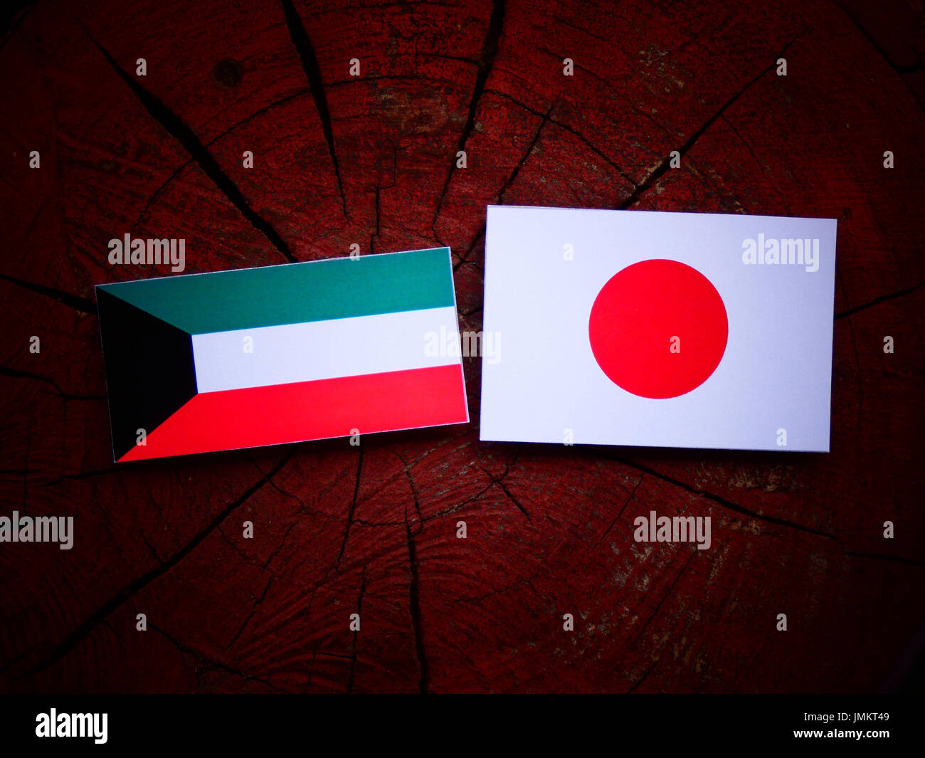 Kuwaiti flag with Japanese flag on a tree stump isolated Stock Photo ...