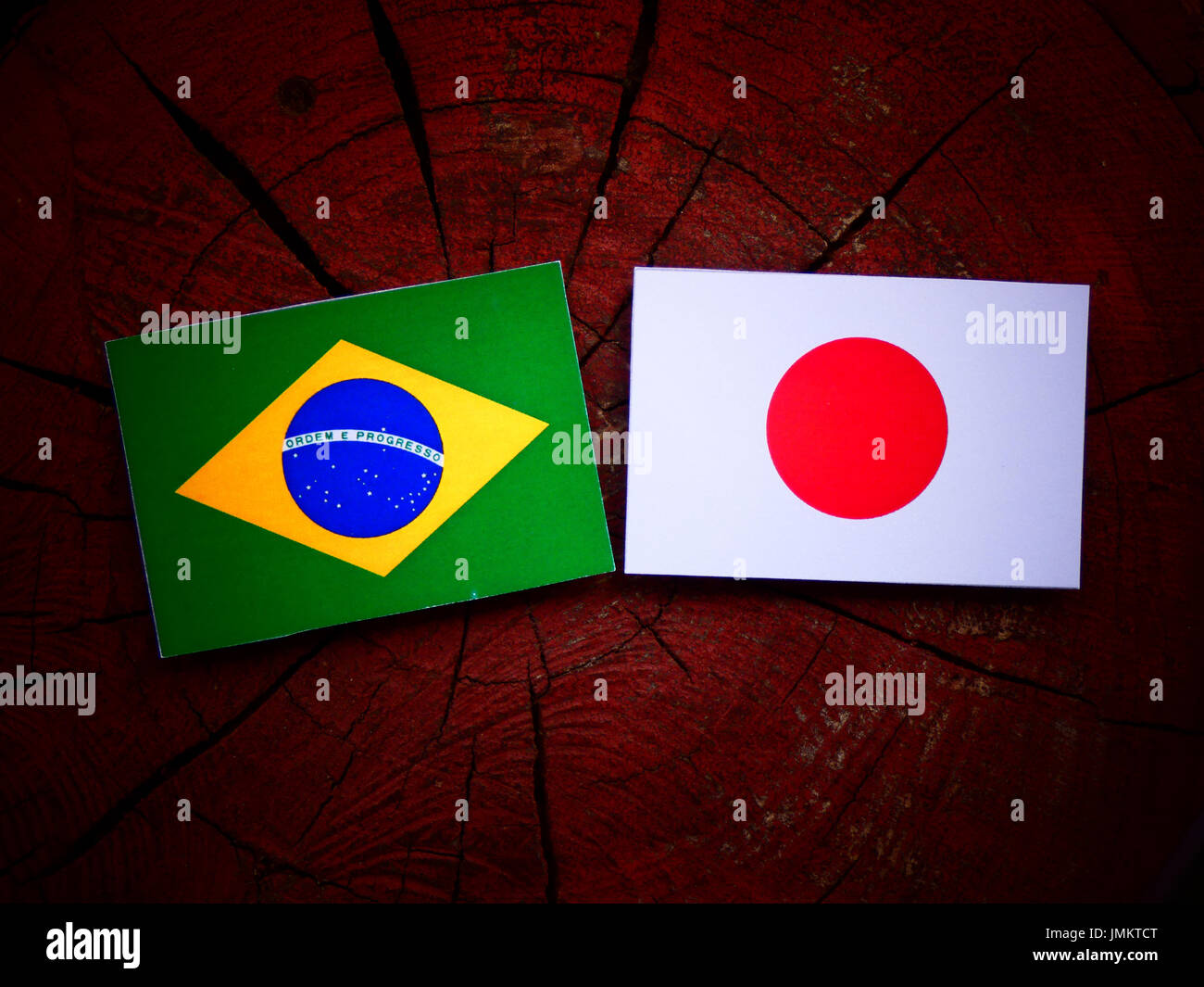 Brazilian flag with Japanese flag on a tree stump isolated Stock Photo ...