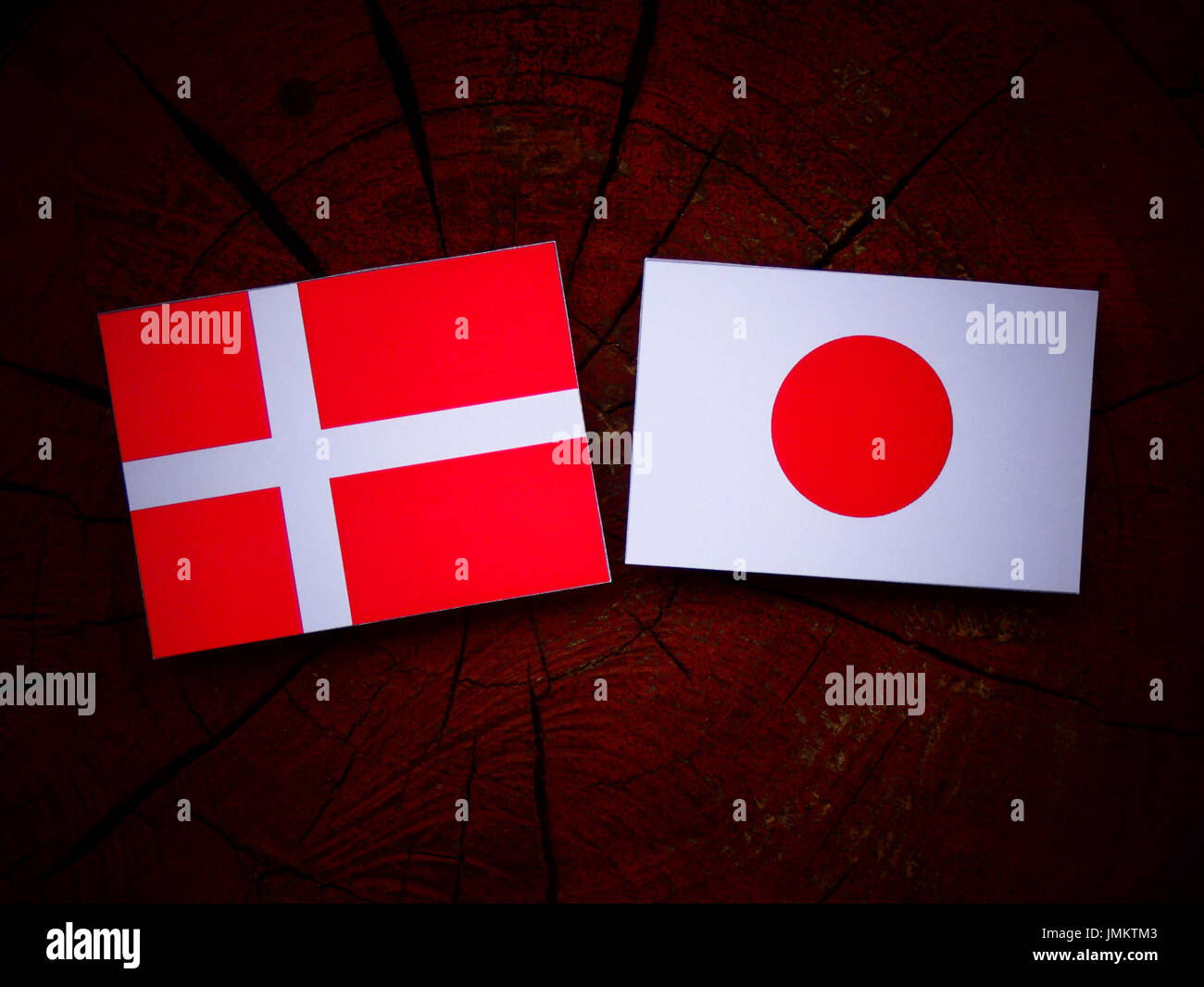 Danish flag with Japanese flag on a tree stump isolated Stock Photo - Alamy