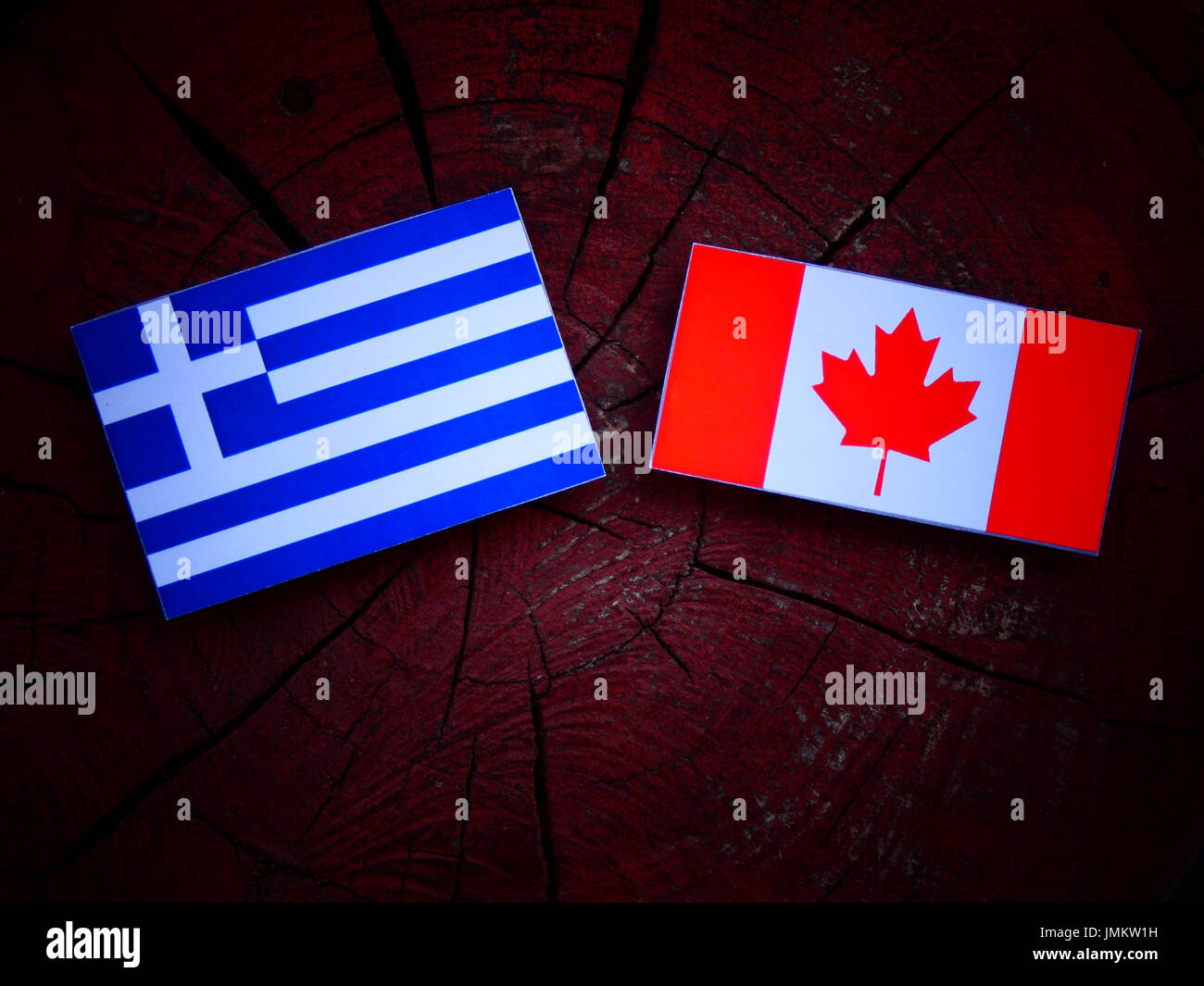 Greek flag with Canadian flag on a tree stump isolated Stock Photo - Alamy