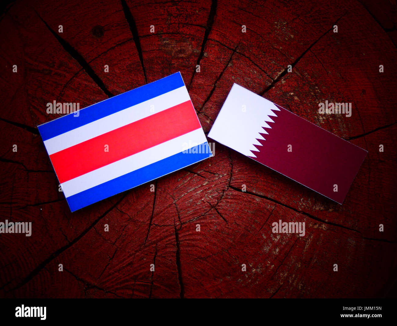 Costa Rican flag with Qatari flag on a tree stump isolated Stock Photo ...