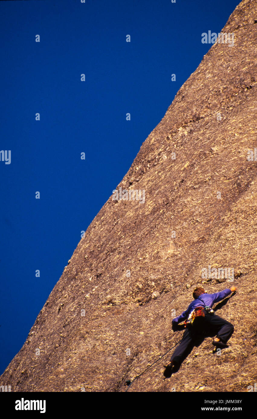 Rock climbers ascend the sheer cliffs on the backside of Mt. Rushmore ...