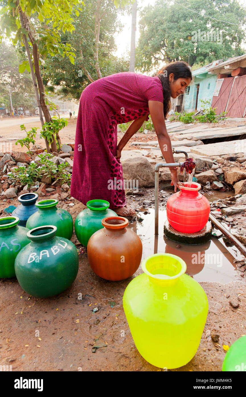 Woman fetching water hi-res stock photography and images - Alamy