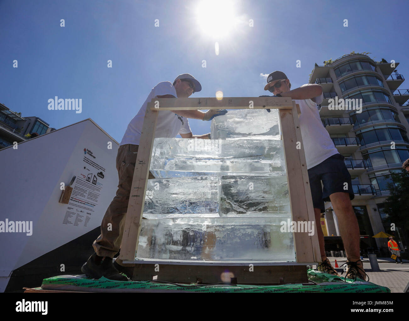 Vancouver, Canada. 27th July, 2017. Workers stack up ice blocks during ...