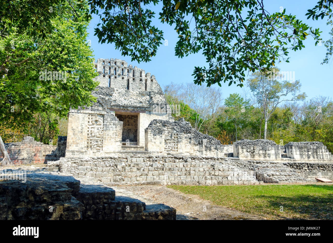 View of temple between trees in Chicanna Mayan ruins in the Yucatan ...