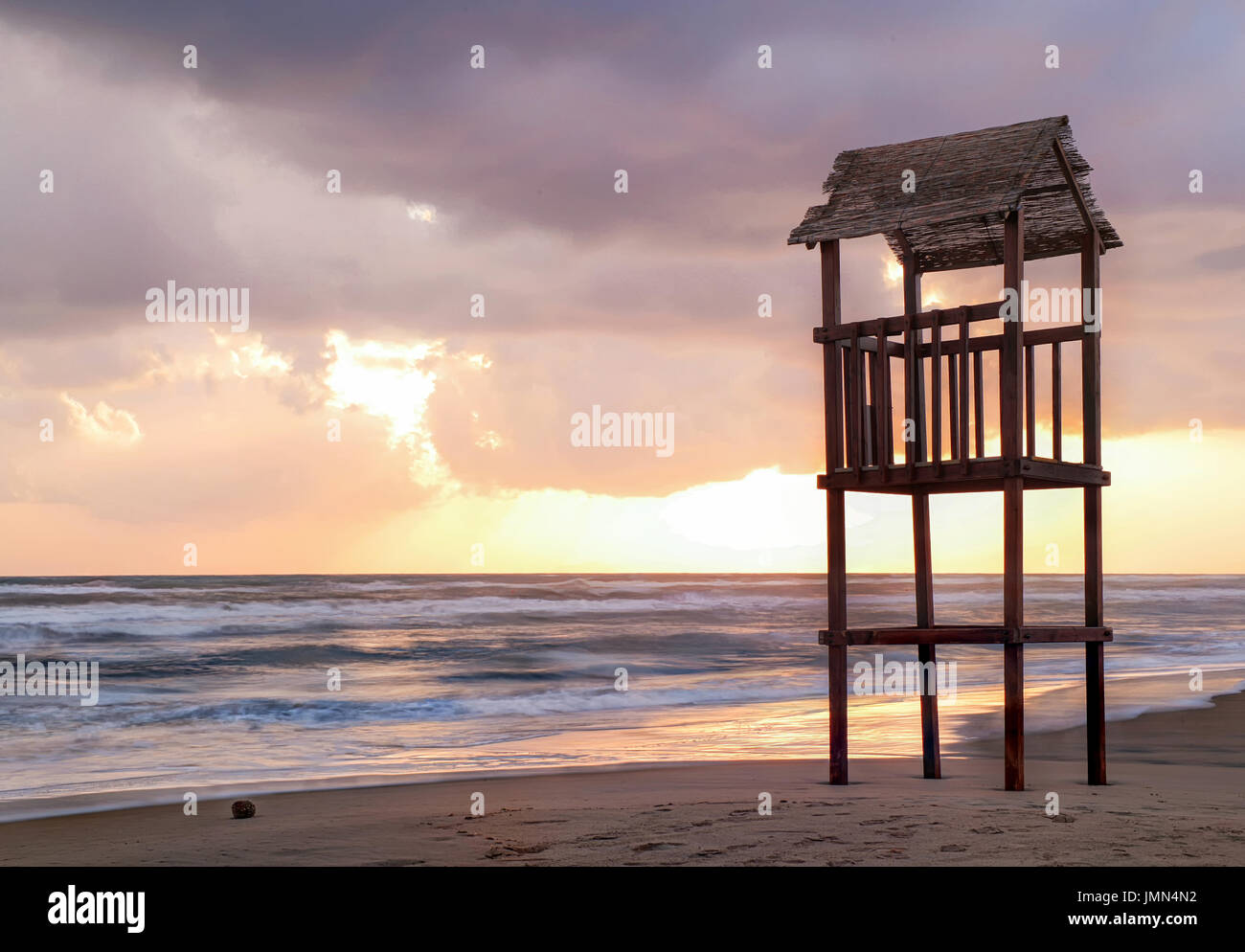 Landscape of beach with rough sea and the wooden lookout tower at ...