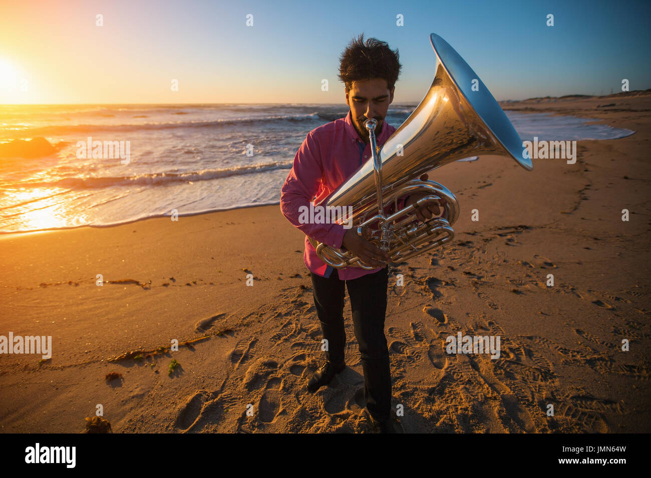 Musician instrumentalist playing the Tuba on the sea coast Stock Photo ...