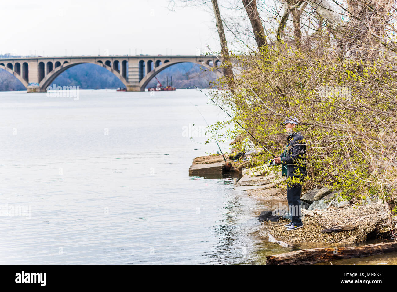 Washington DC, USA - March 20, 2017: Person fishing on riverfront in ...