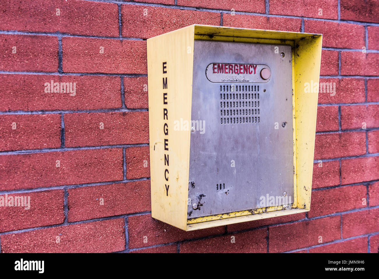 Emergency single button call station on brick wall closeup Stock Photo ...