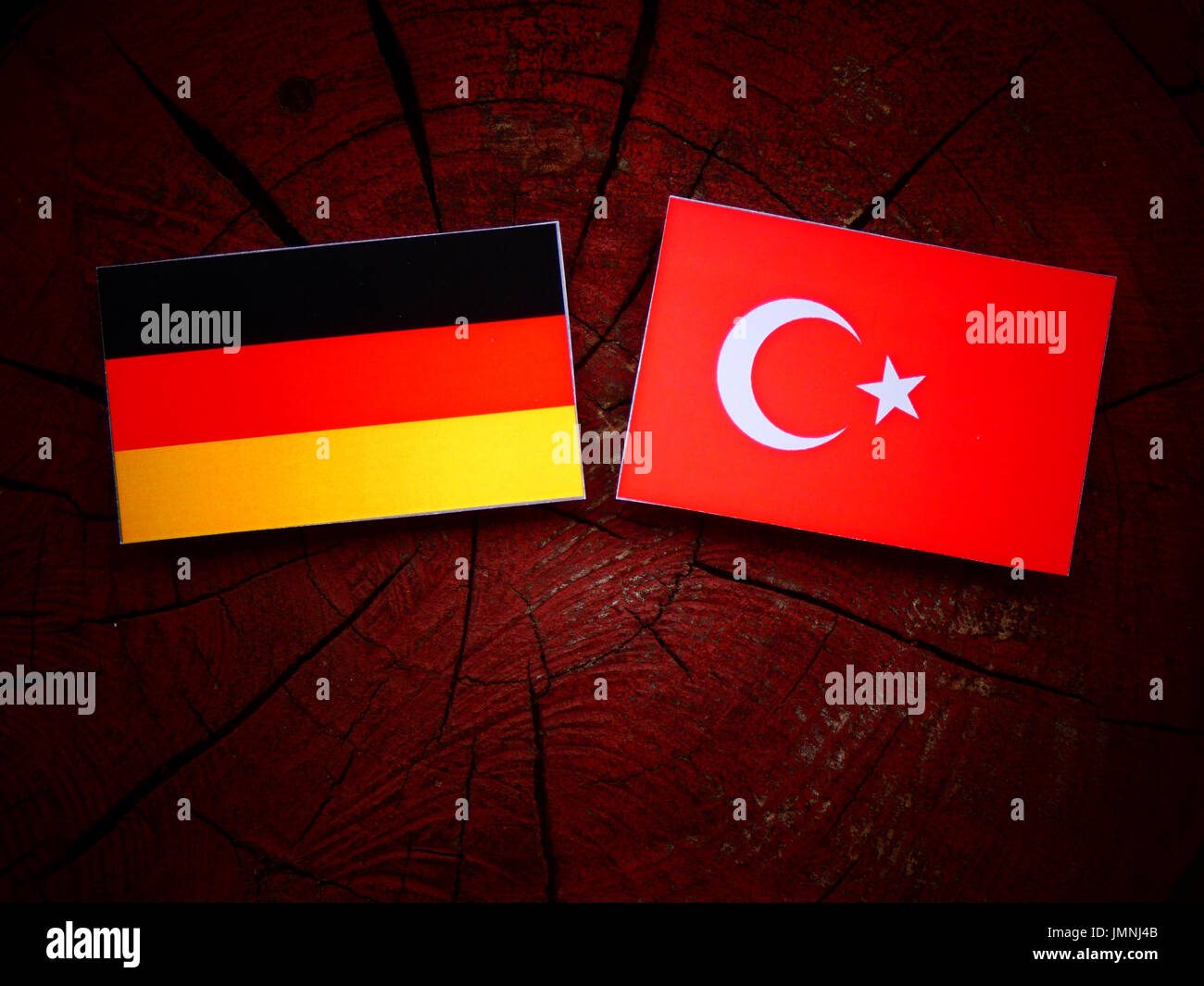 German flag with Turkish flag on a tree stump isolated Stock Photo - Alamy