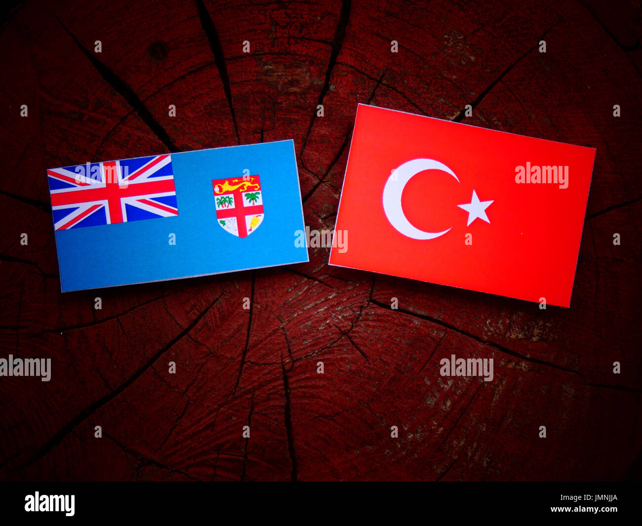 Fijian flag with Turkish flag on a tree stump isolated Stock Photo - Alamy
