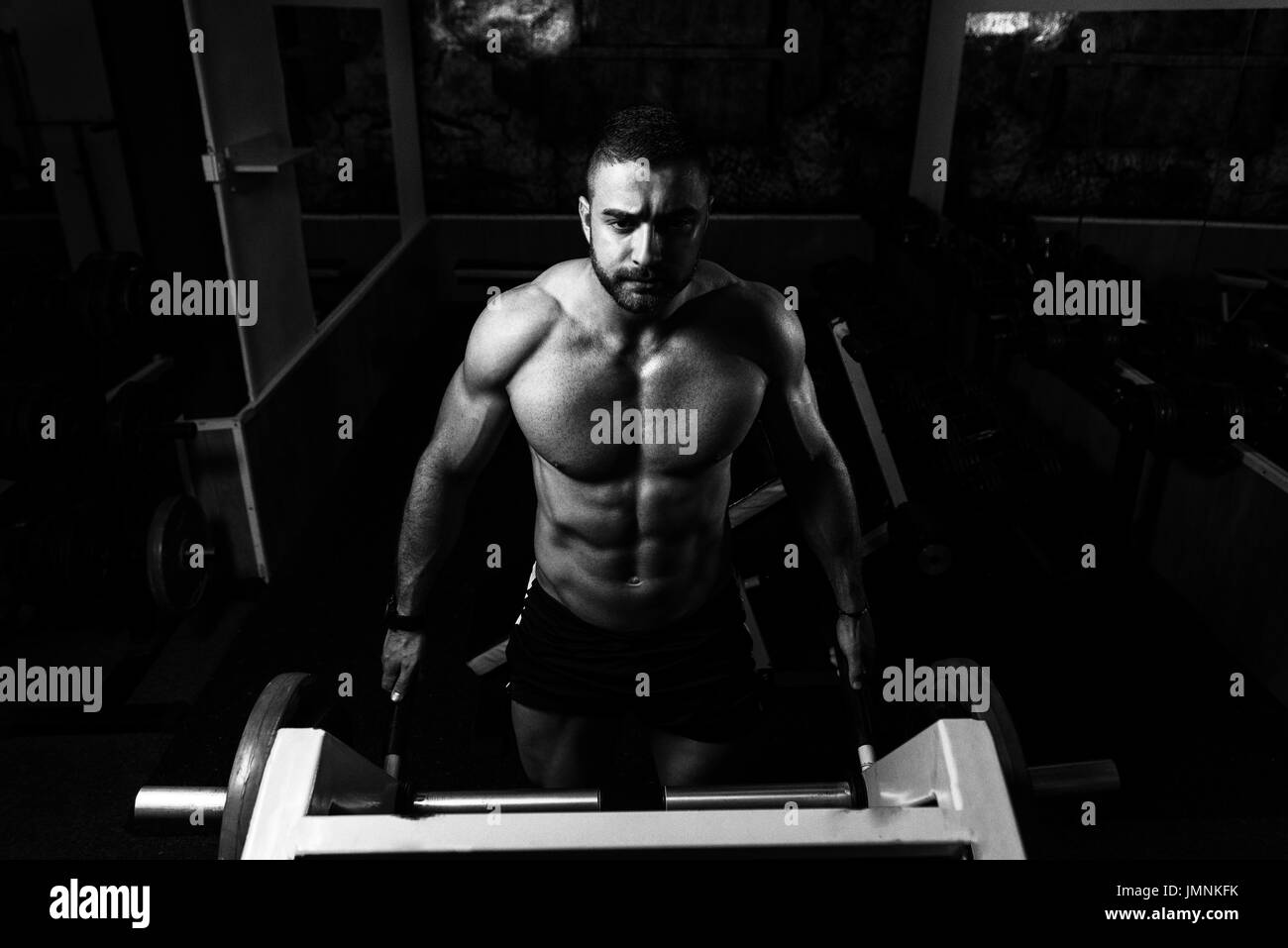 Model Doing Heavy Weight Exercise For Trapezius On Machine Stock Photo ...