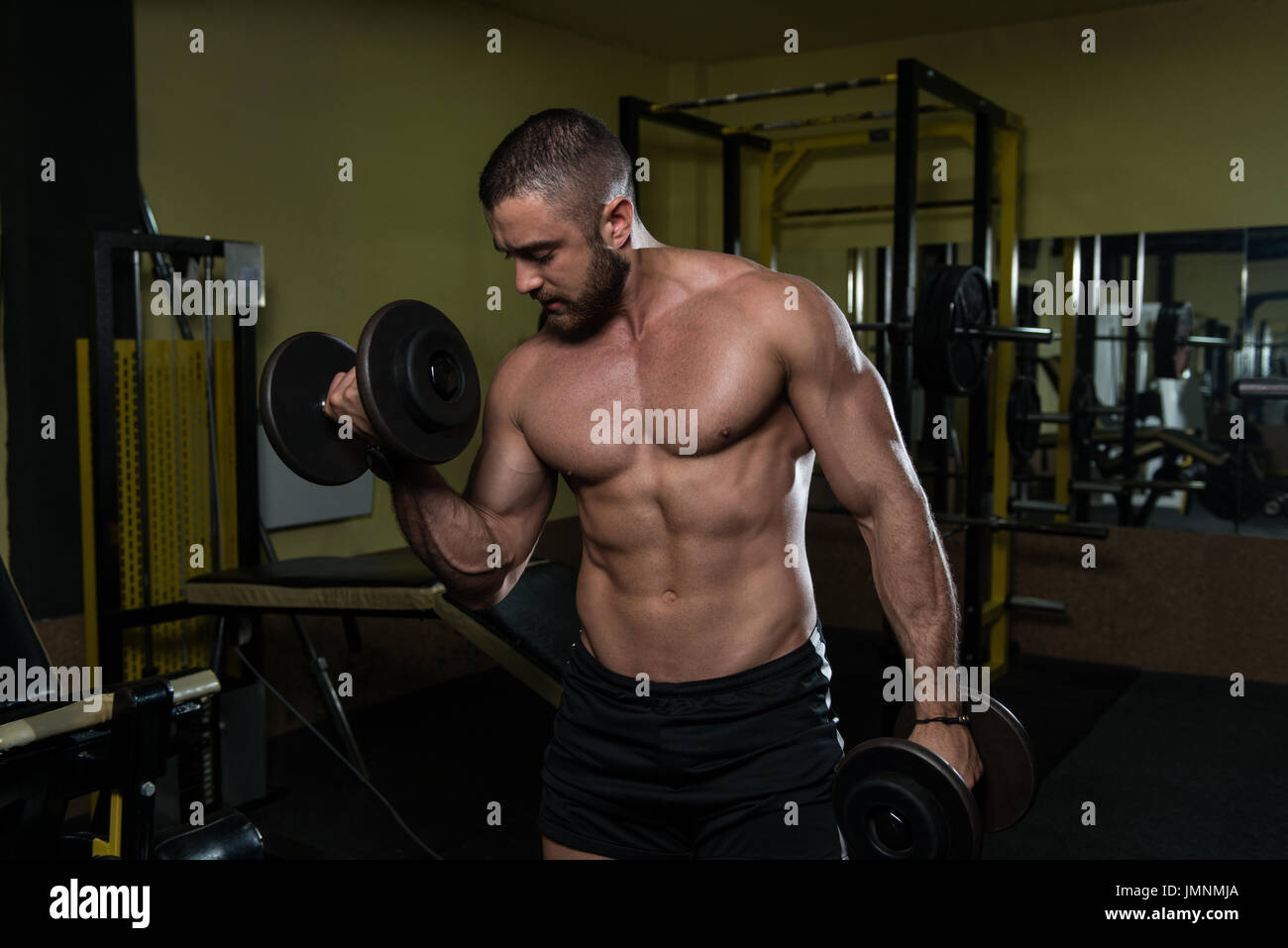 Athlete Working Out Biceps In A Gym - Dumbbell Concentration Curls ...
