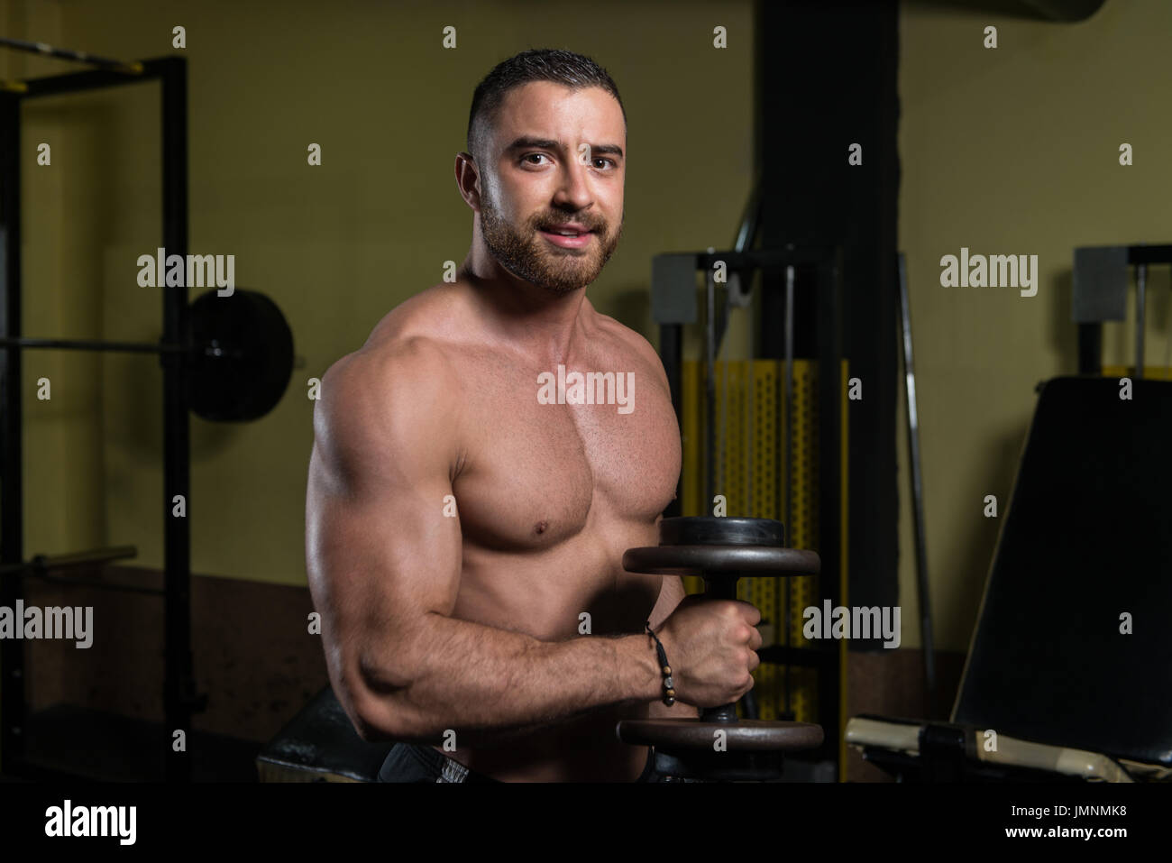 Man Working Out Biceps In A Gym - Dumbbell Concentration Curls Stock ...