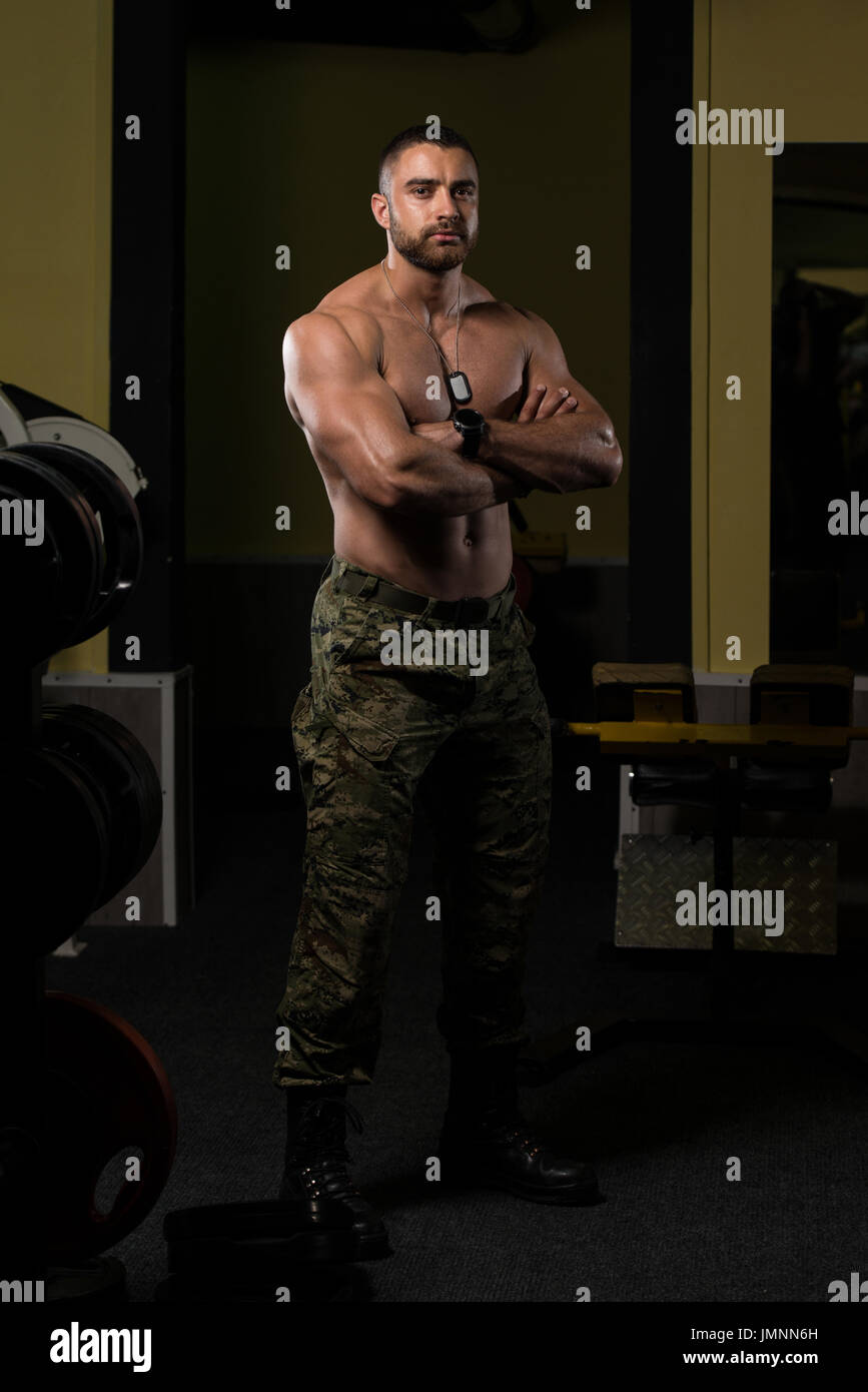 Healthy Man Standing Strong In Army Pants And Flexing Muscles ...