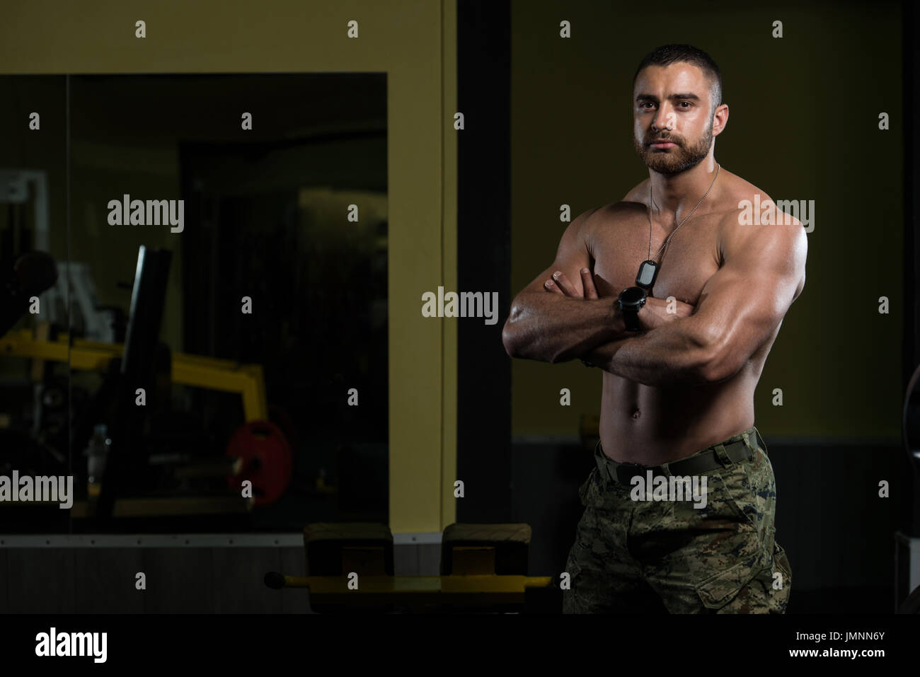 Handsome Young Man Standing Strong In Army Pants And Flexing Muscles ...