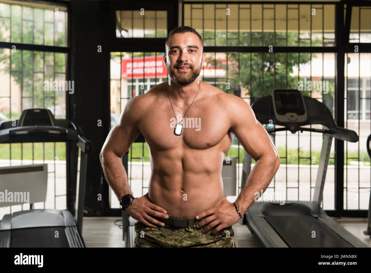 Healthy Man Standing Strong In Army Pants And Flexing Muscles ...