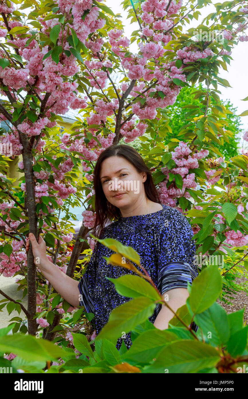 Woman standing tree park blooming hi-res stock photography and images ...