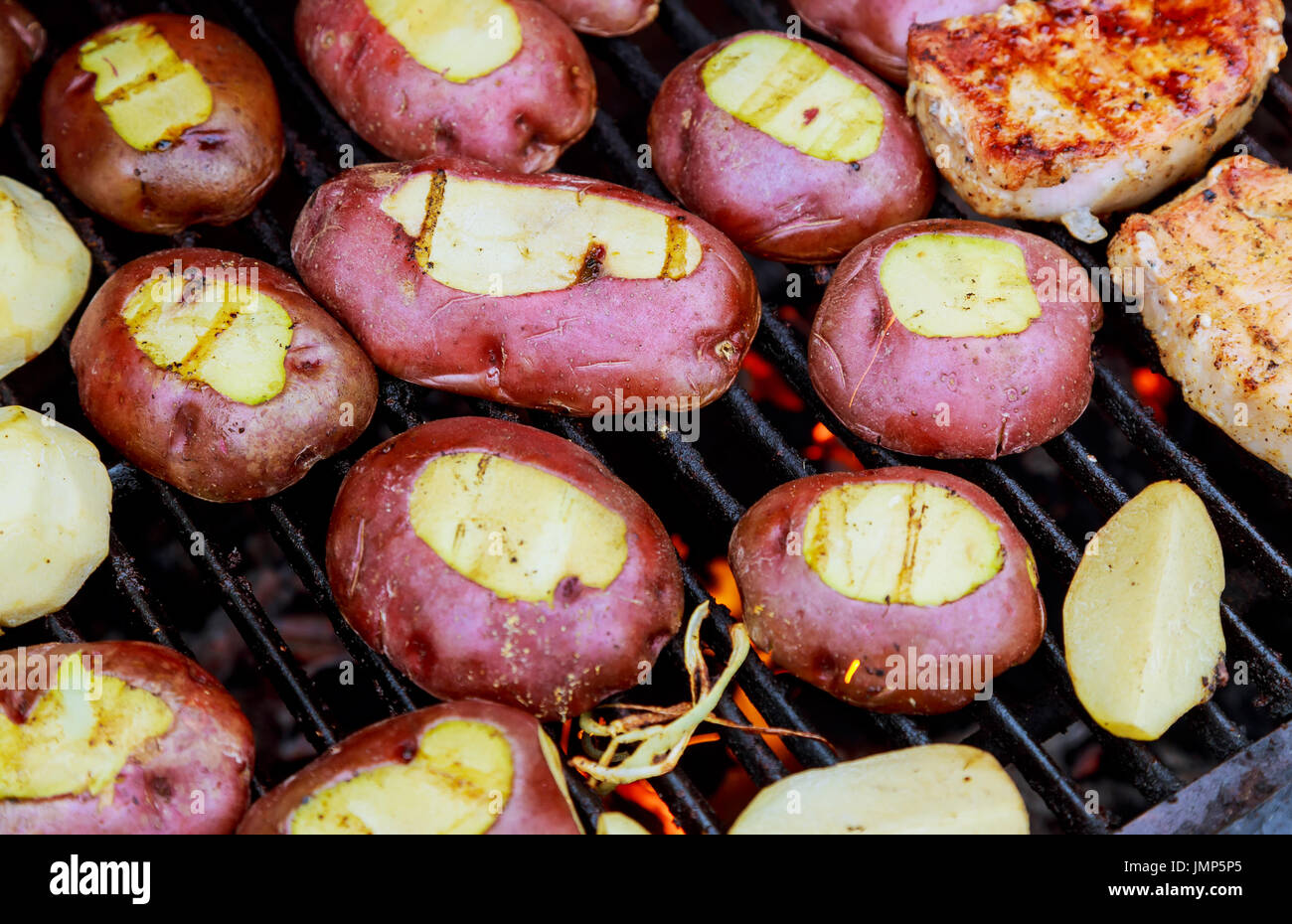 Big Slice Of Village-Style Potatoes On Hot BBQ Charcoal Grill. Flames ...