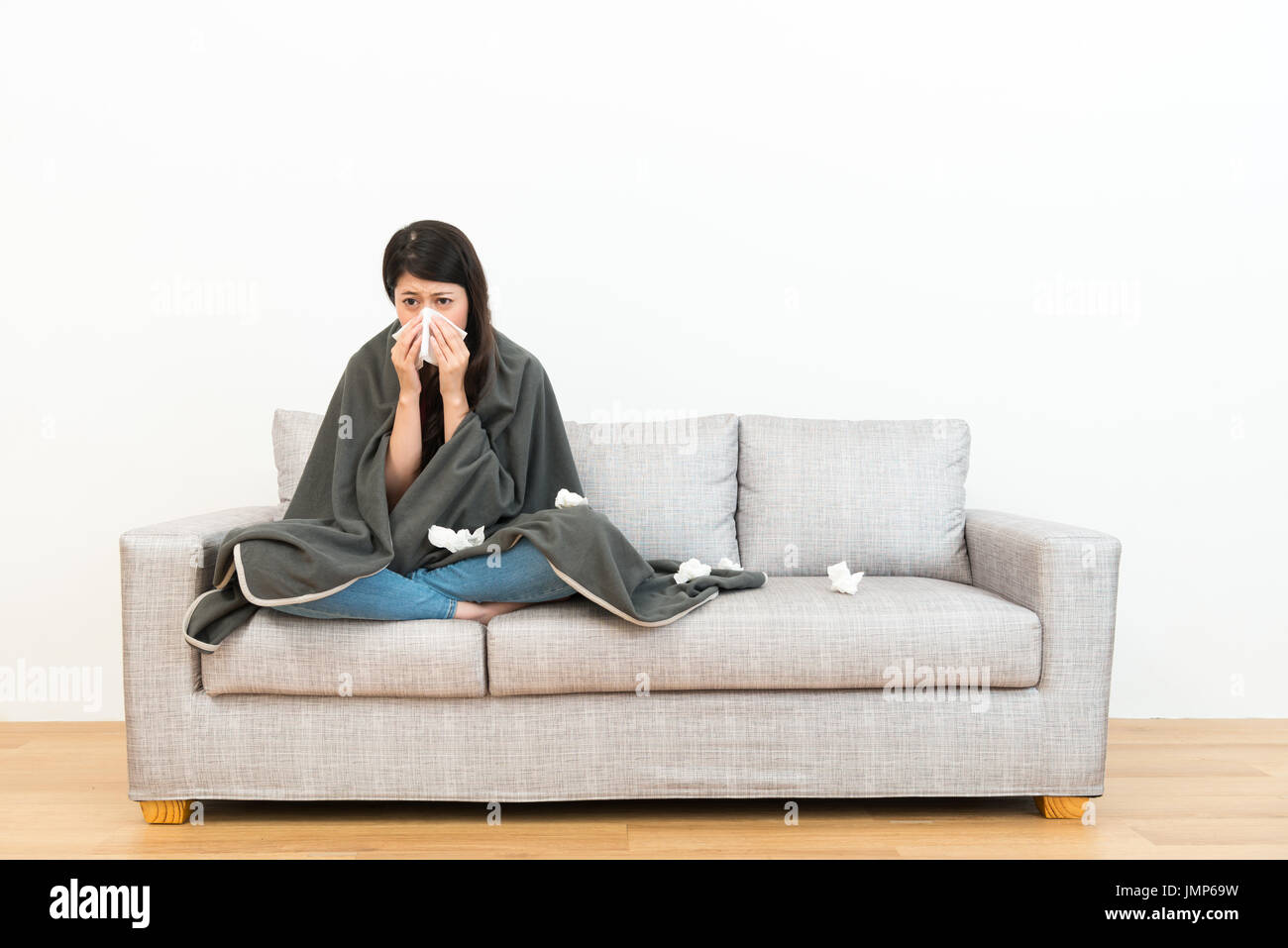 beautiful pretty female teenagner catching a cold resting on sofa couch ...
