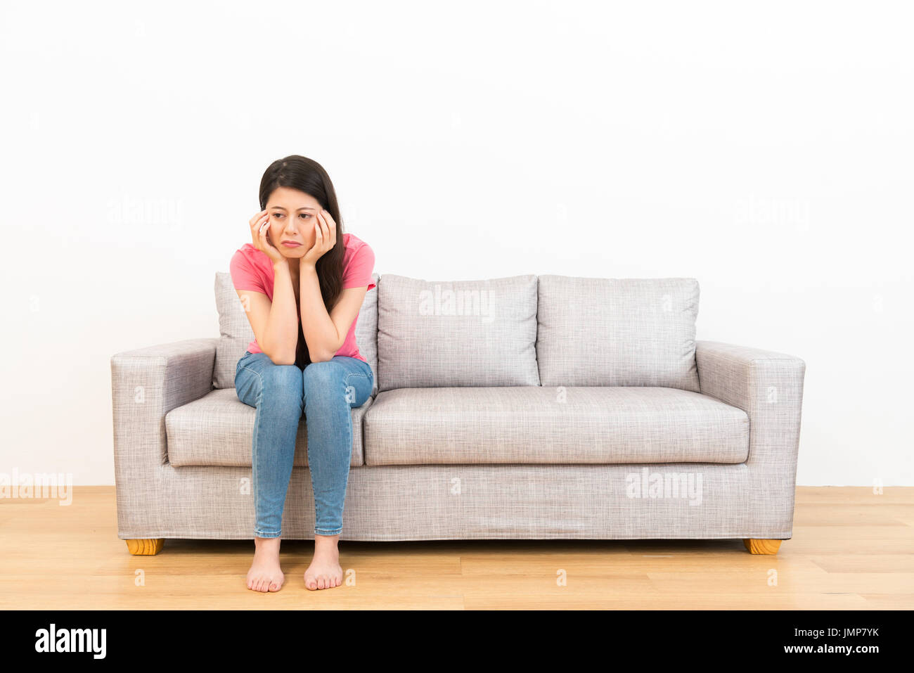 sad woman sitting on couch and weeping crying thinking of bad news ...