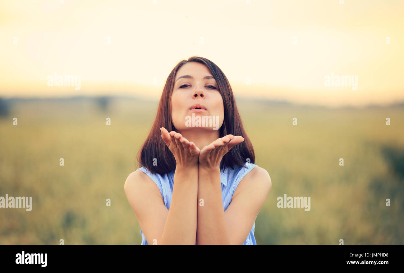 Girl blowing a kiss closeup. Woman on fresh air blowing a kiss Stock ...