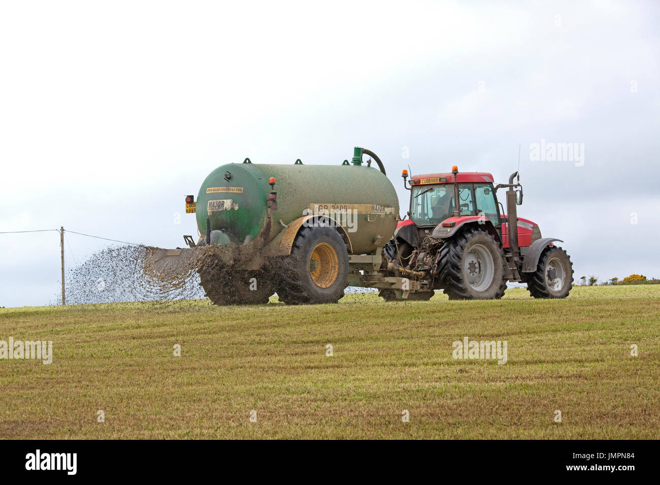 Tractor working with muck spreader Pembrokeshire UK Stock Photo - Alamy