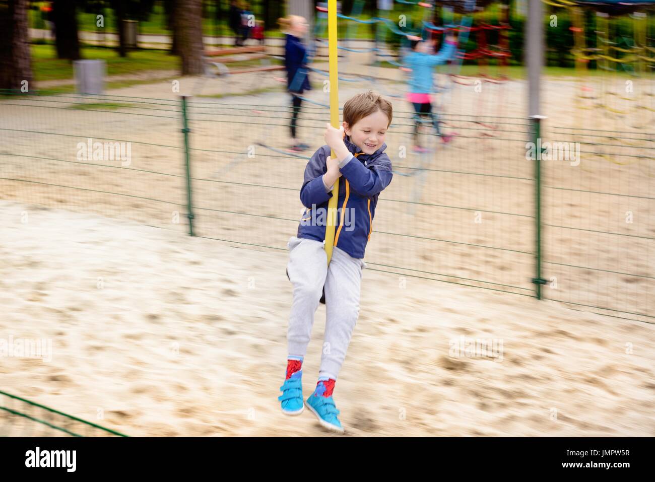 Boy sliding on a rope hi-res stock photography and images - Alamy