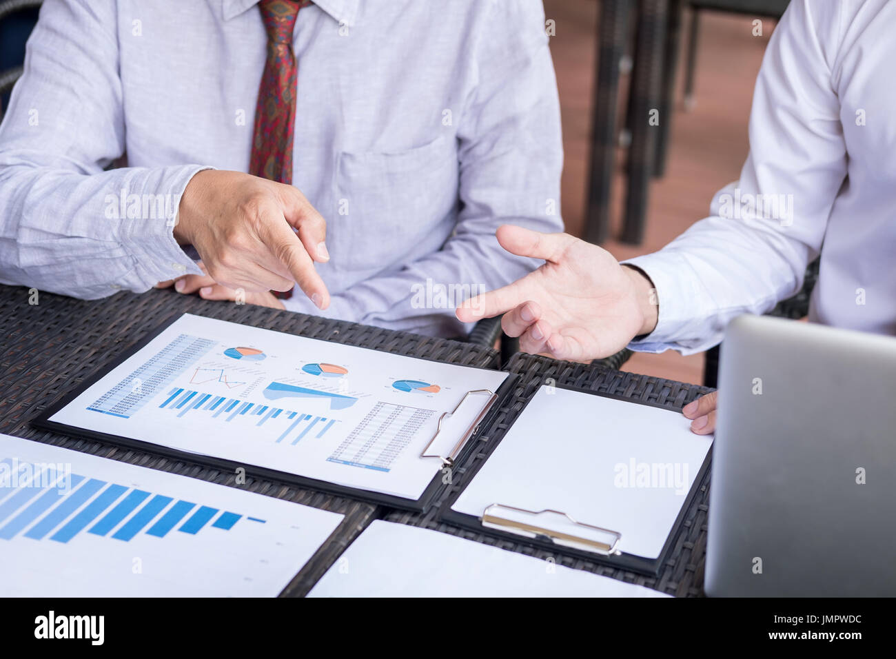 Business people discuss together about there work by graph document and ...