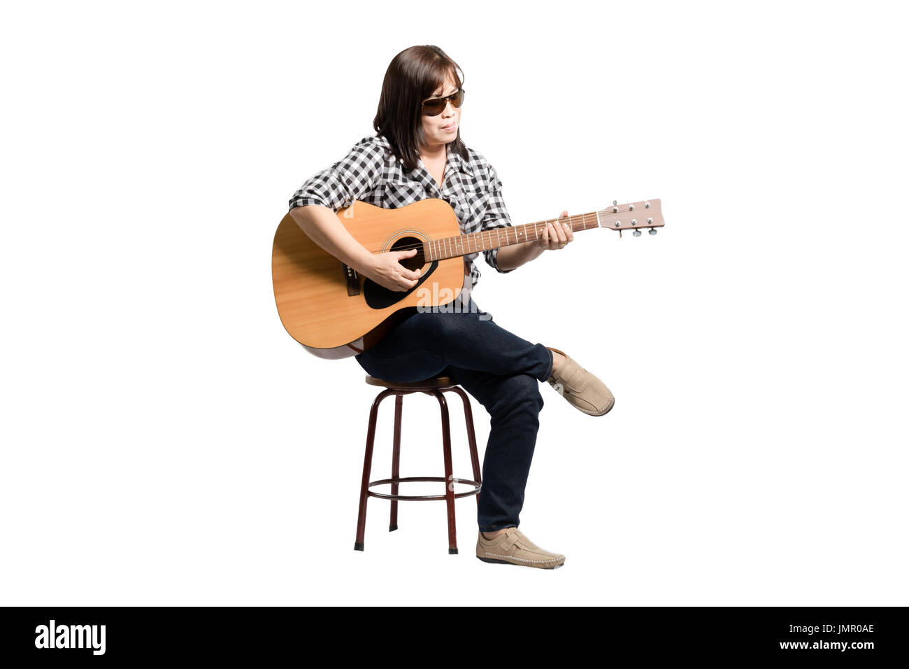 Portrait of a mature woman playing guitar. Isolated on white background ...