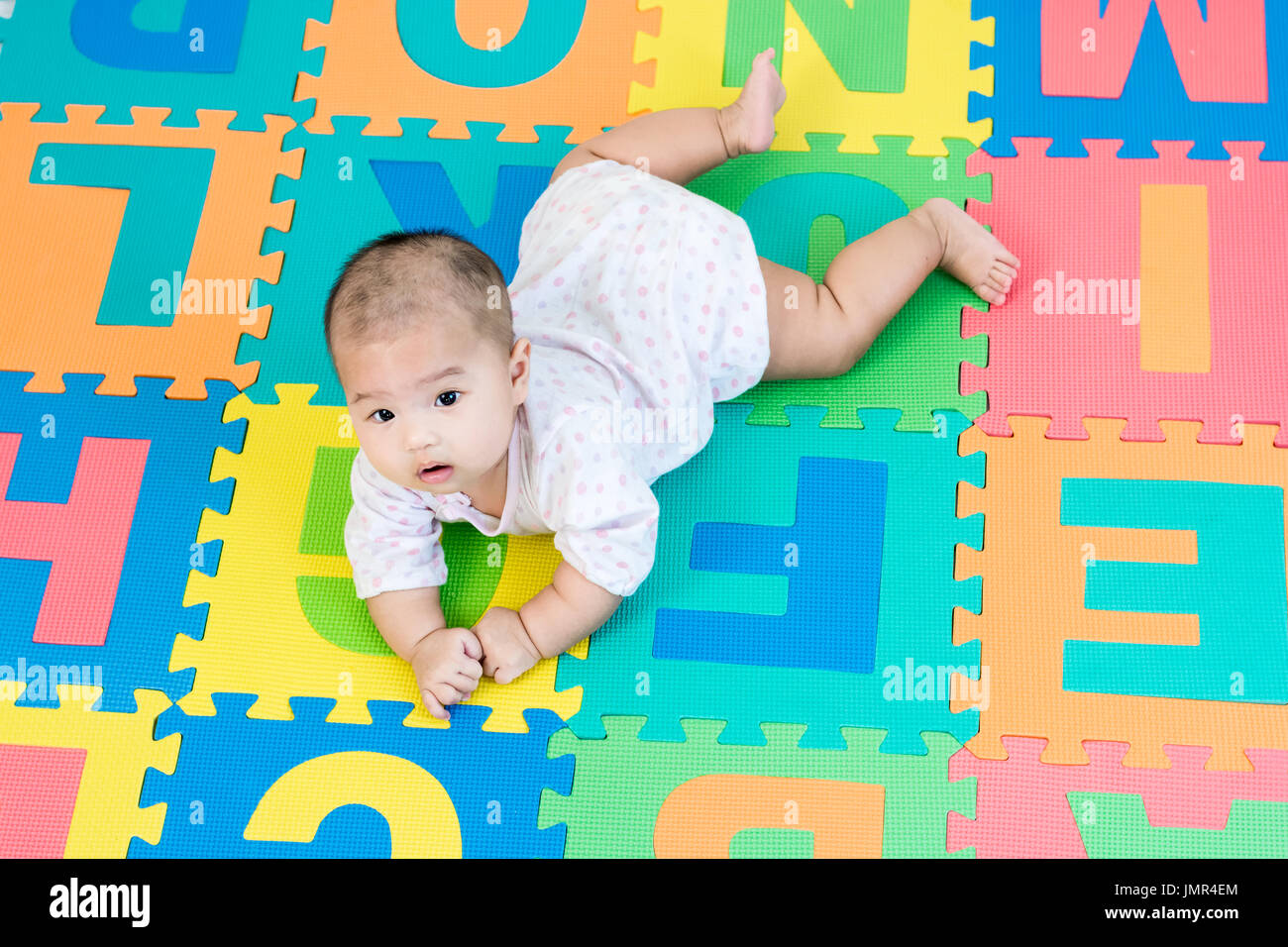 Portrait of a little adorable newborn infant baby girl with saliva ...