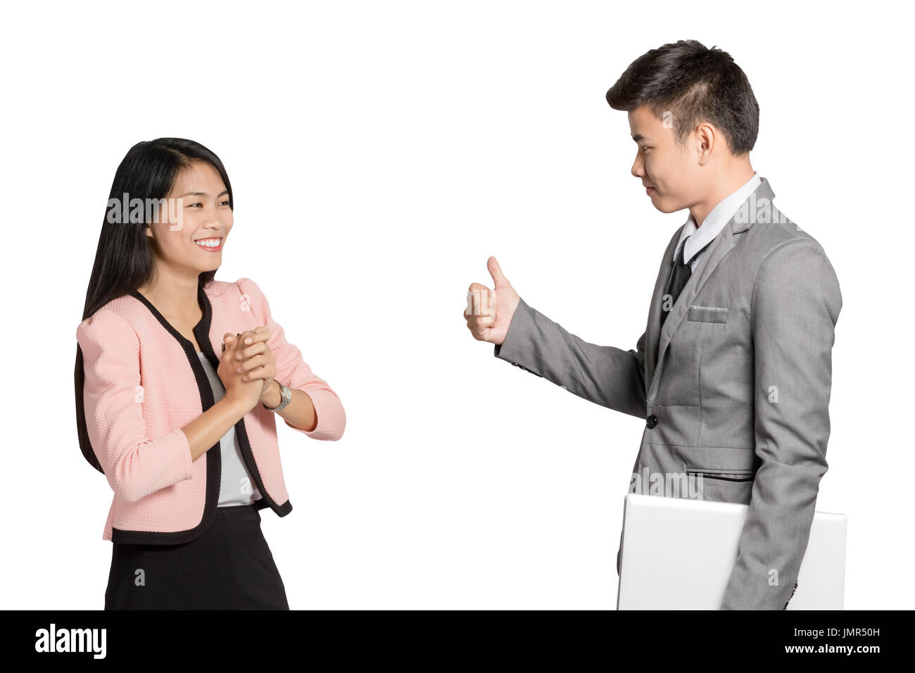 Portrait of two colleagues. Young businessman showing his thumbs up for ...