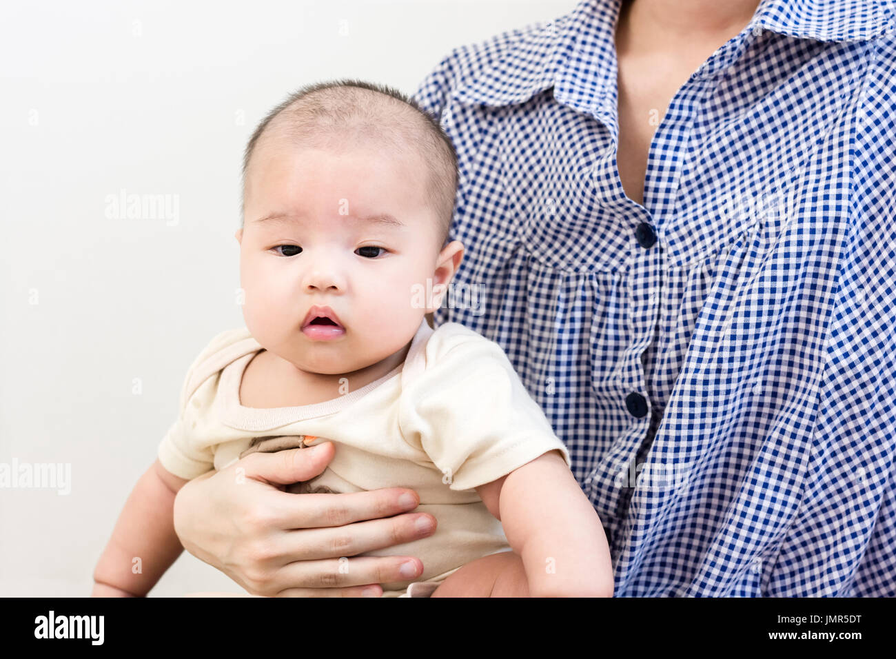 Portrait of a little adorable newborn infant baby girl sitting on ...