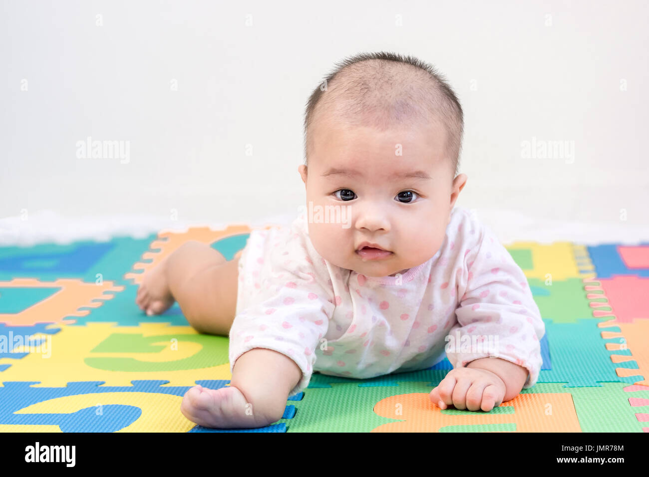 Portrait of a little adorable newborn infant baby girl with saliva ...