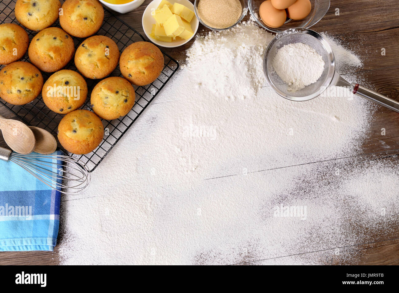 Baking background with dusted flour on a dark wood table with freshly ...