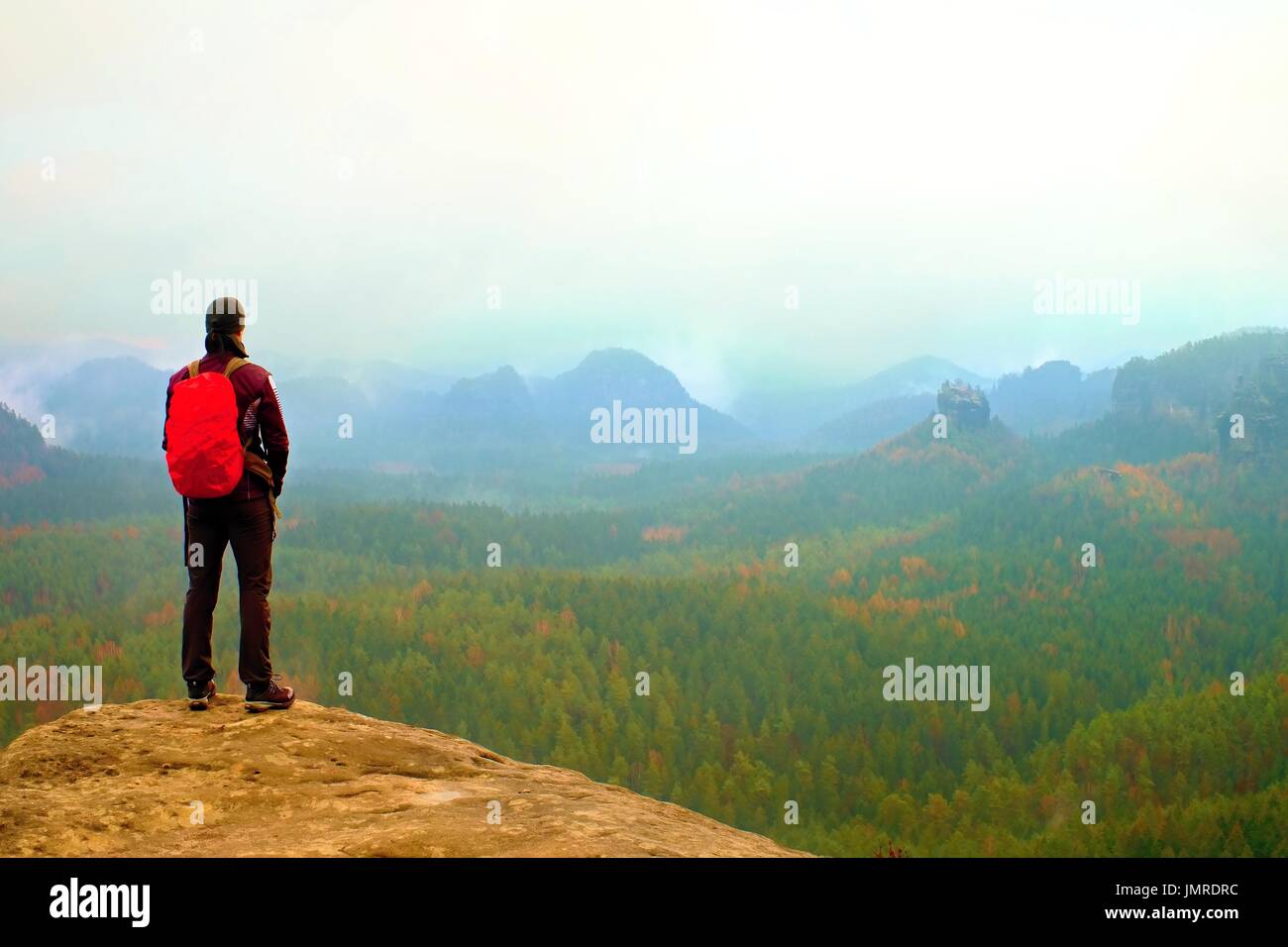 Hiker with red backpack on sharp sandstone rock in rock empires park ...