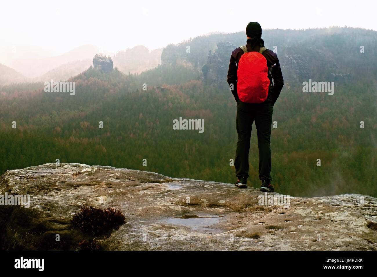 Hiker with red backpack on sharp sandstone rock in rock empires park ...