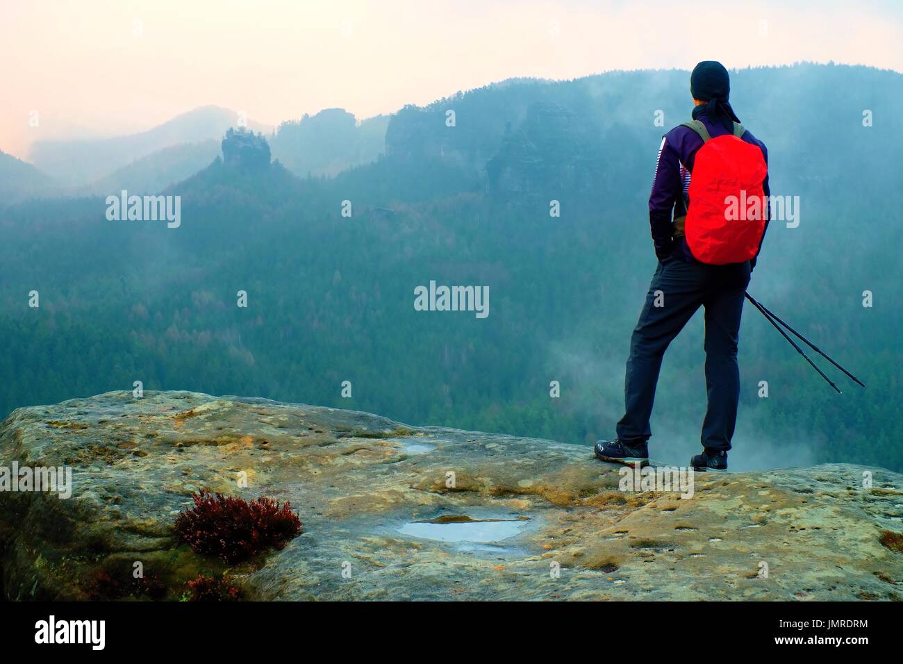 Hiker with red backpack on sharp sandstone rock in rock empires park ...