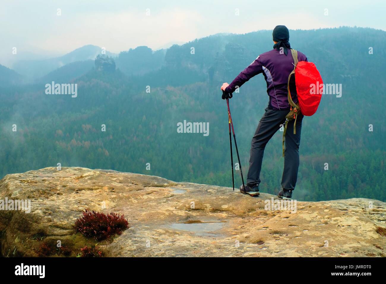 Hiker with red backpack on sharp sandstone rock in rock empires park ...