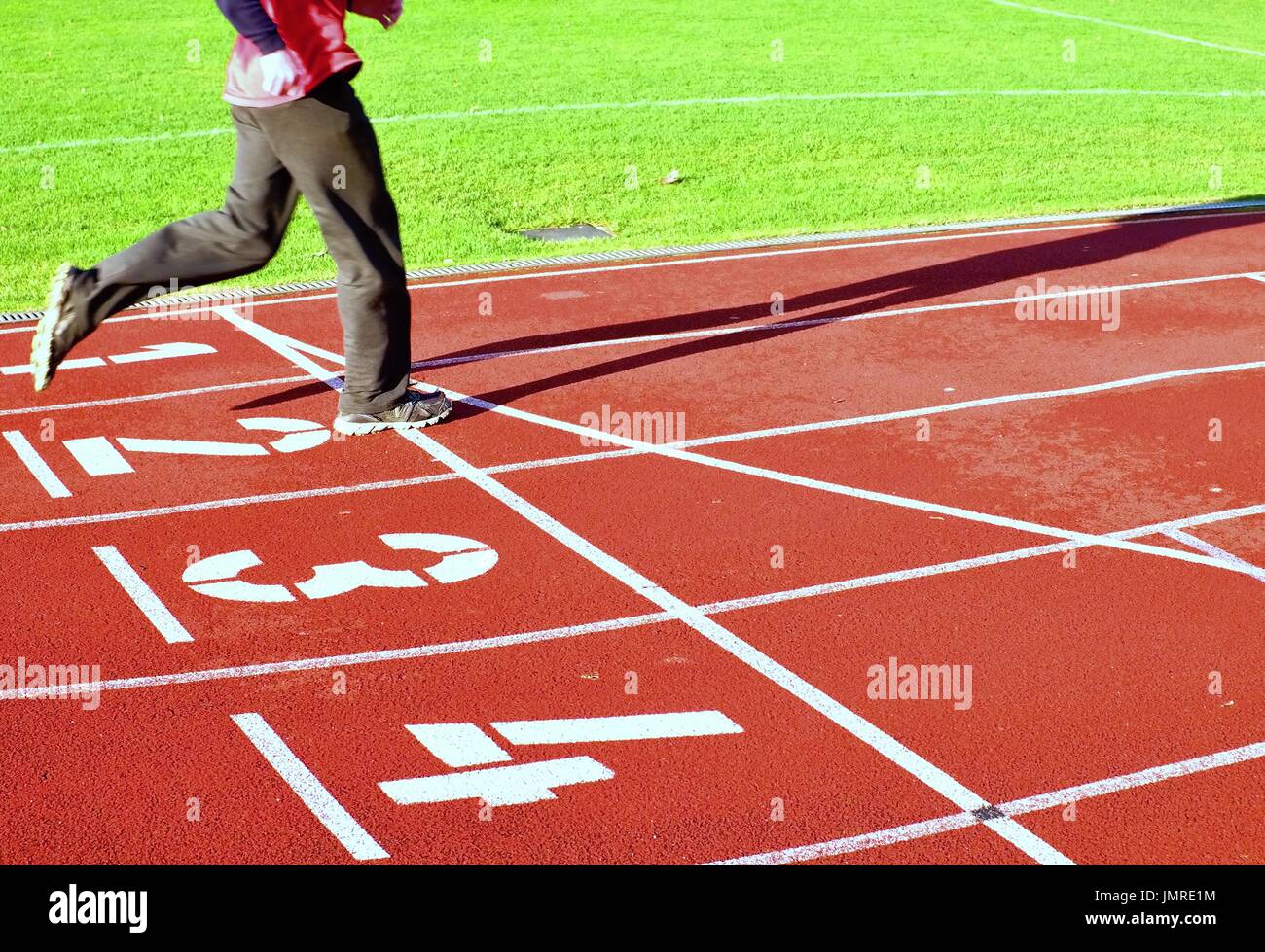 Red running racetrack on the stadium with two running legs Stock Photo ...