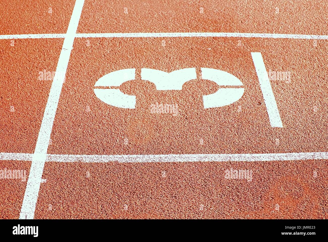 Number three. White track number on red rubber racetrack, texture of ...