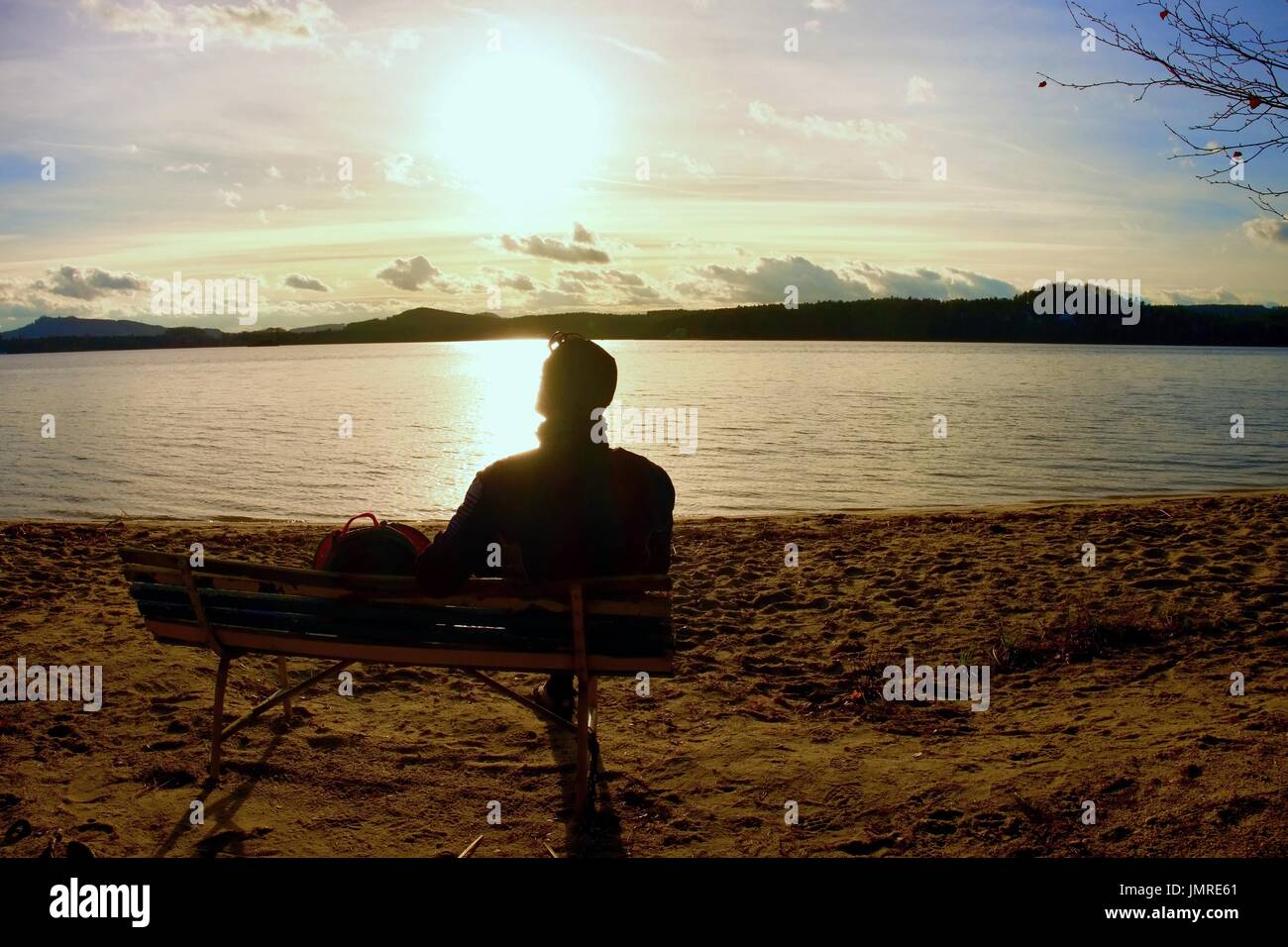 Alone Young Man In Silhouette Sitting In The Sun. Tourist take a rest ...