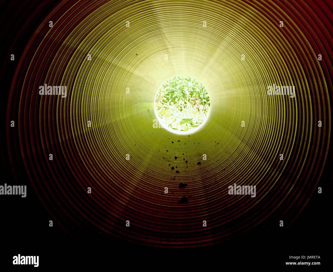 View inside of long plastic tube under ground. Colorful ribbed wall of ...